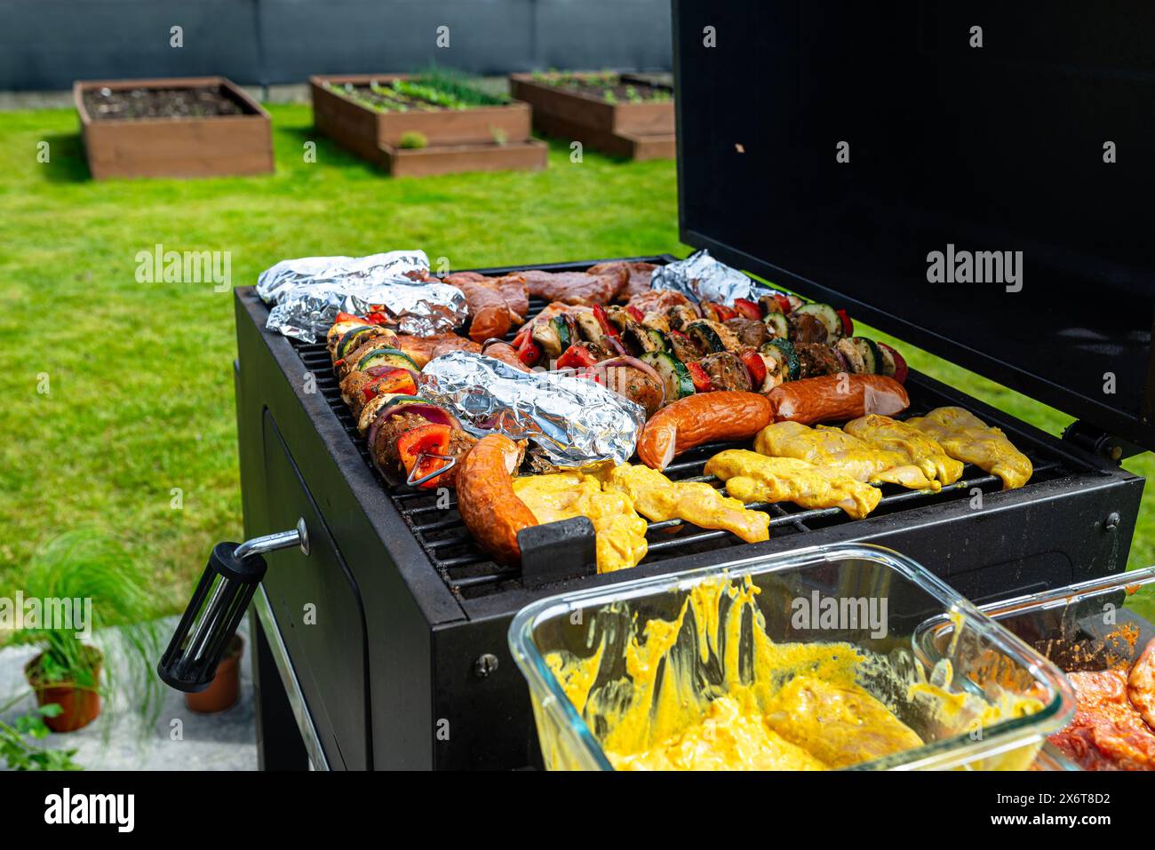 A modern rectangular grill standing on a paving slab on a garden ...