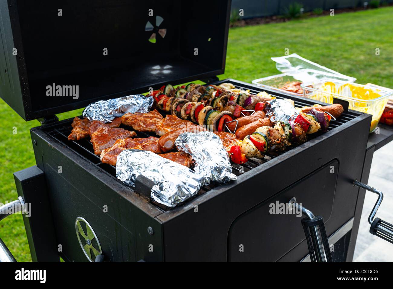 A modern rectangular grill standing on a paving slab on a garden ...