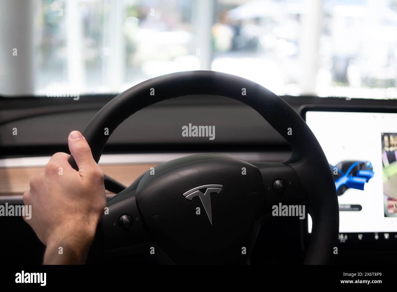 male hand on Driver's column, Behind steering wheel Tesla model Y ...