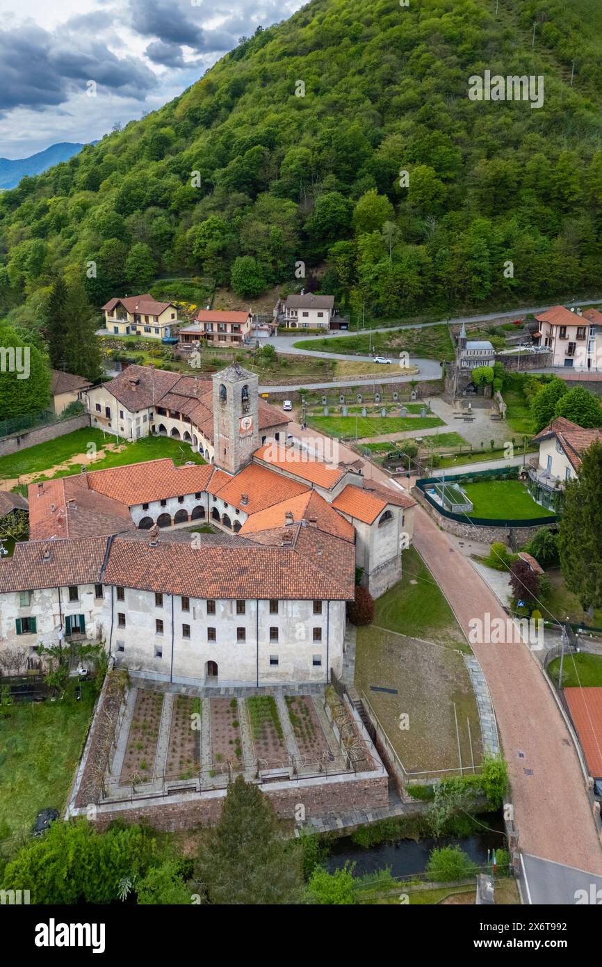 Aerial view of the ancient Badia di San Gemolo in Ganna on a spring day ...
