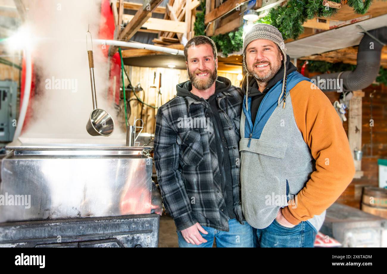 sugar shack, two maple farmer wearing a traditional clothe working ...