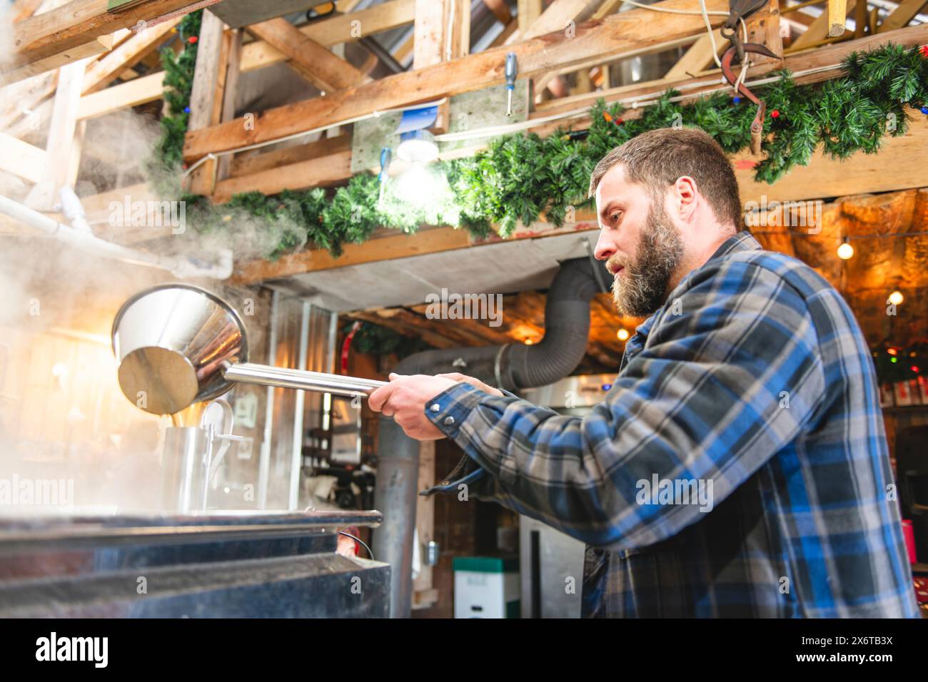 sugar shack, a maple farmer wearing a traditional clothe working doing ...