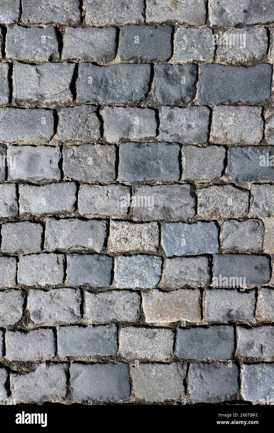 Dark gray cobblestone pavement from old smooth stones as background top ...