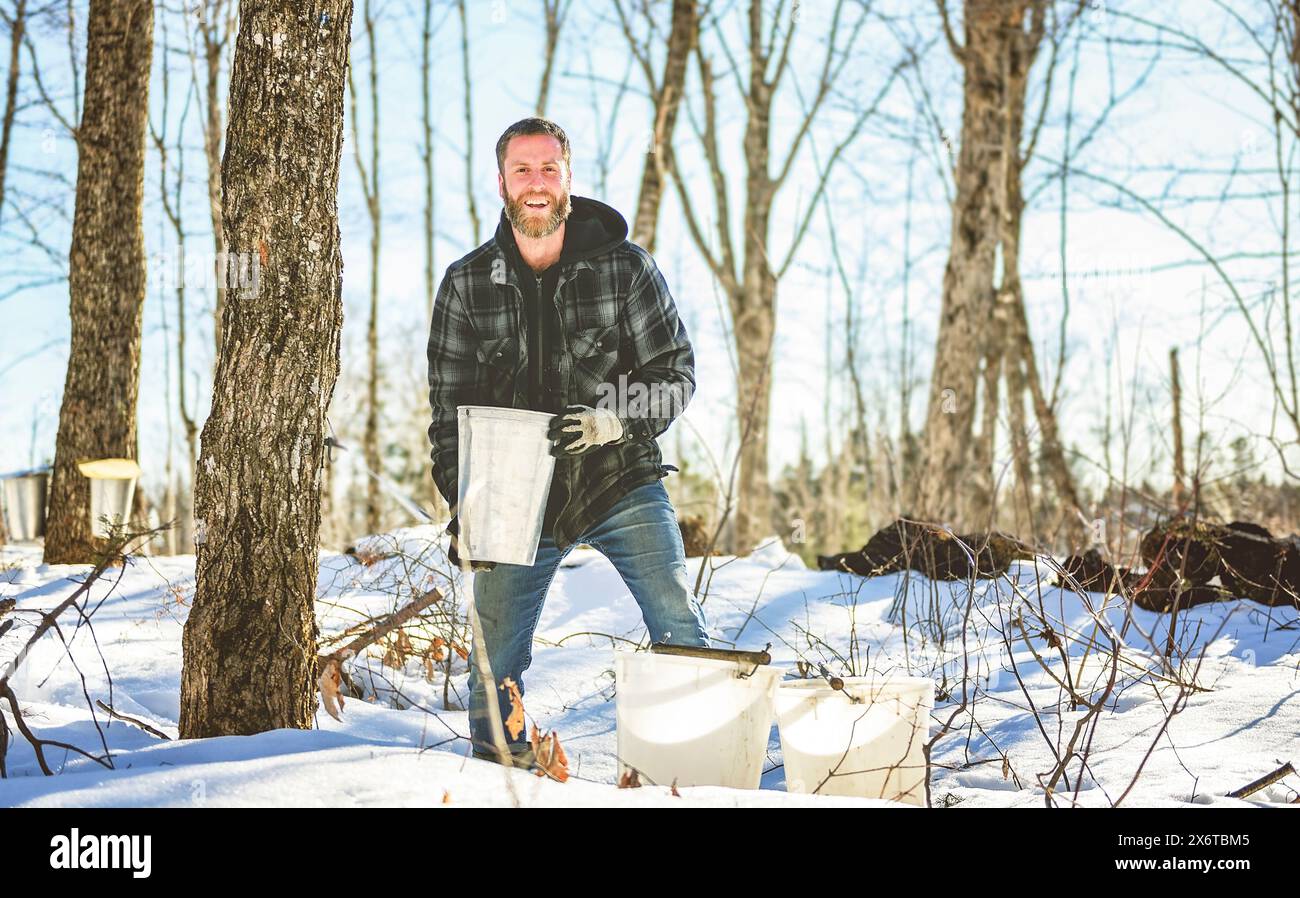 sugar shack, a maple farmer wearing a traditional clothe working take ...