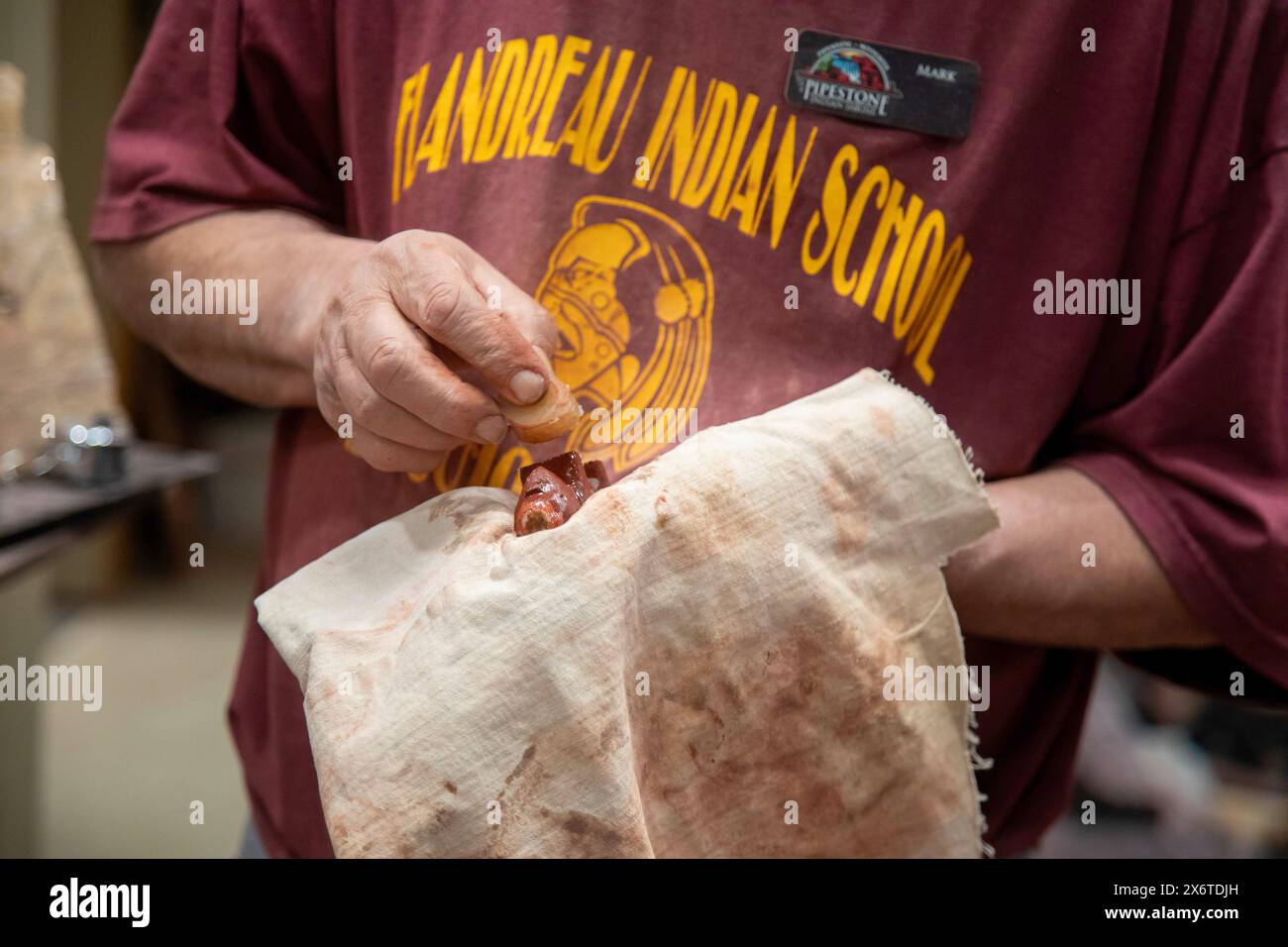 Pipestone, Minnesota - A Native American polishes a pipe he has made ...