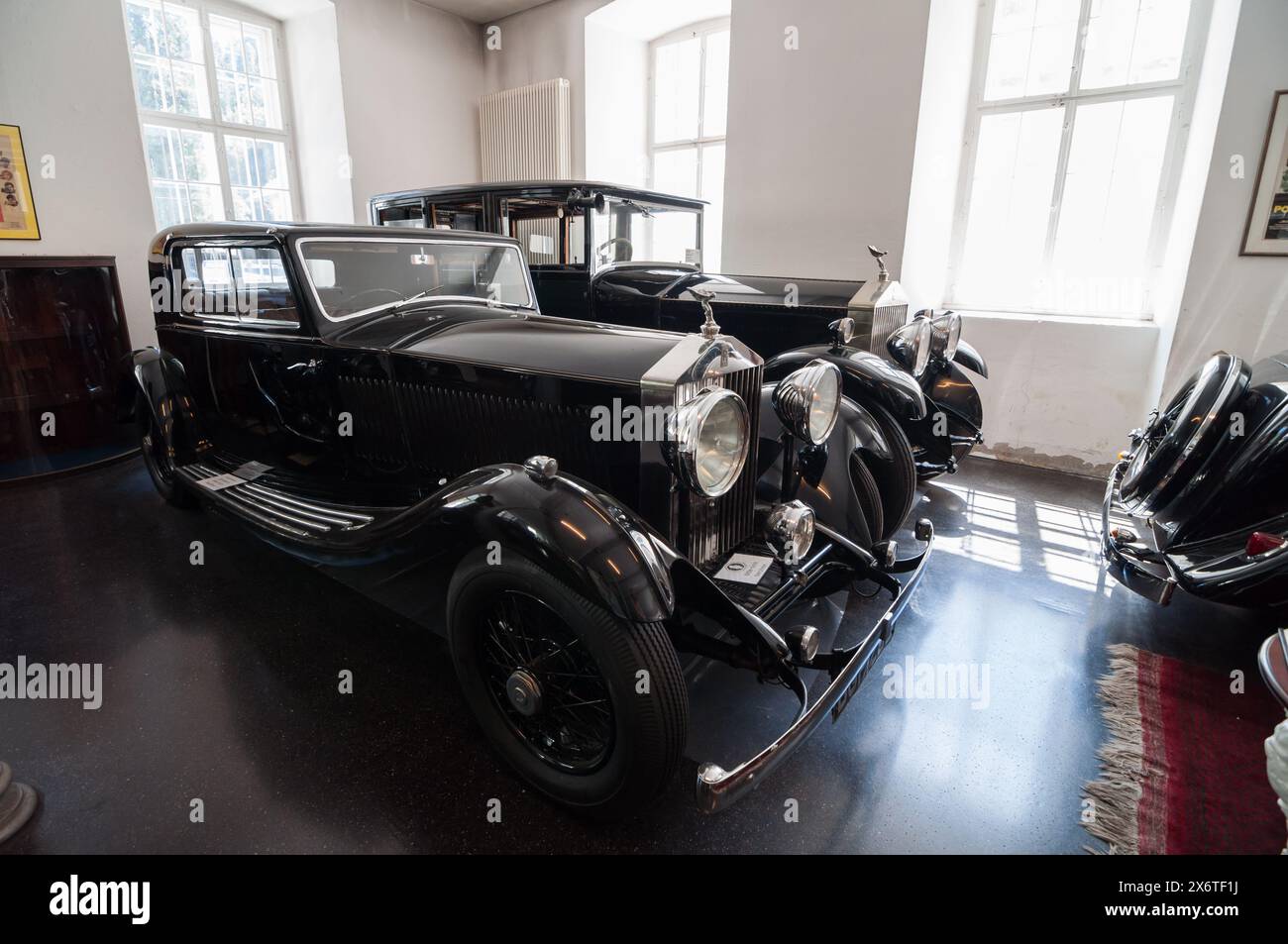 Rolls-Royce Museum in Dornbirn. Two black vintage cars in a building of ...