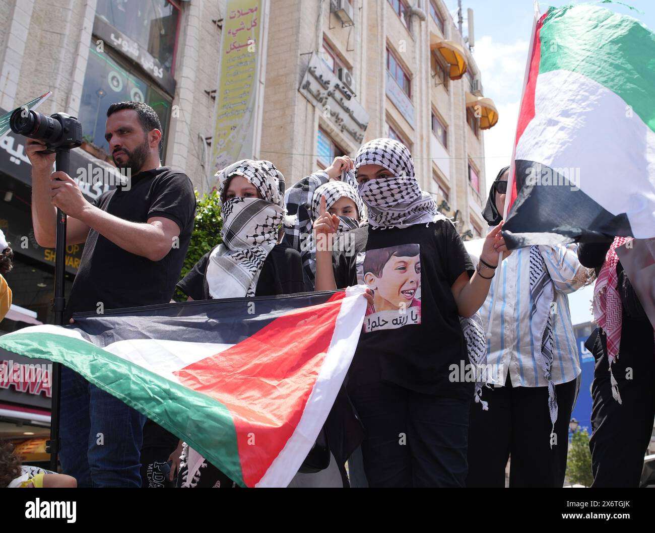 People putting up Palestinian flags march in Ramallah, West Bank on May ...