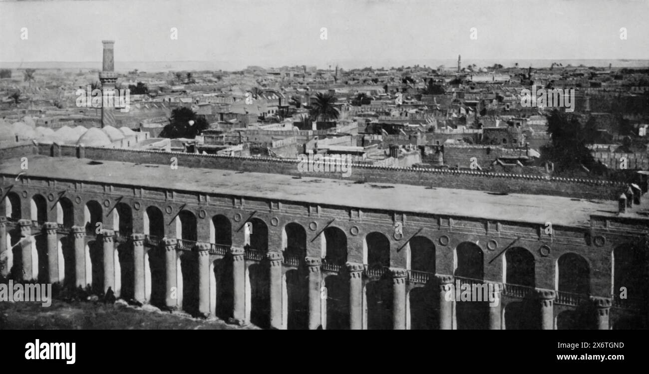 A photograph shows a view of Baghdad city with a military barracks in ...