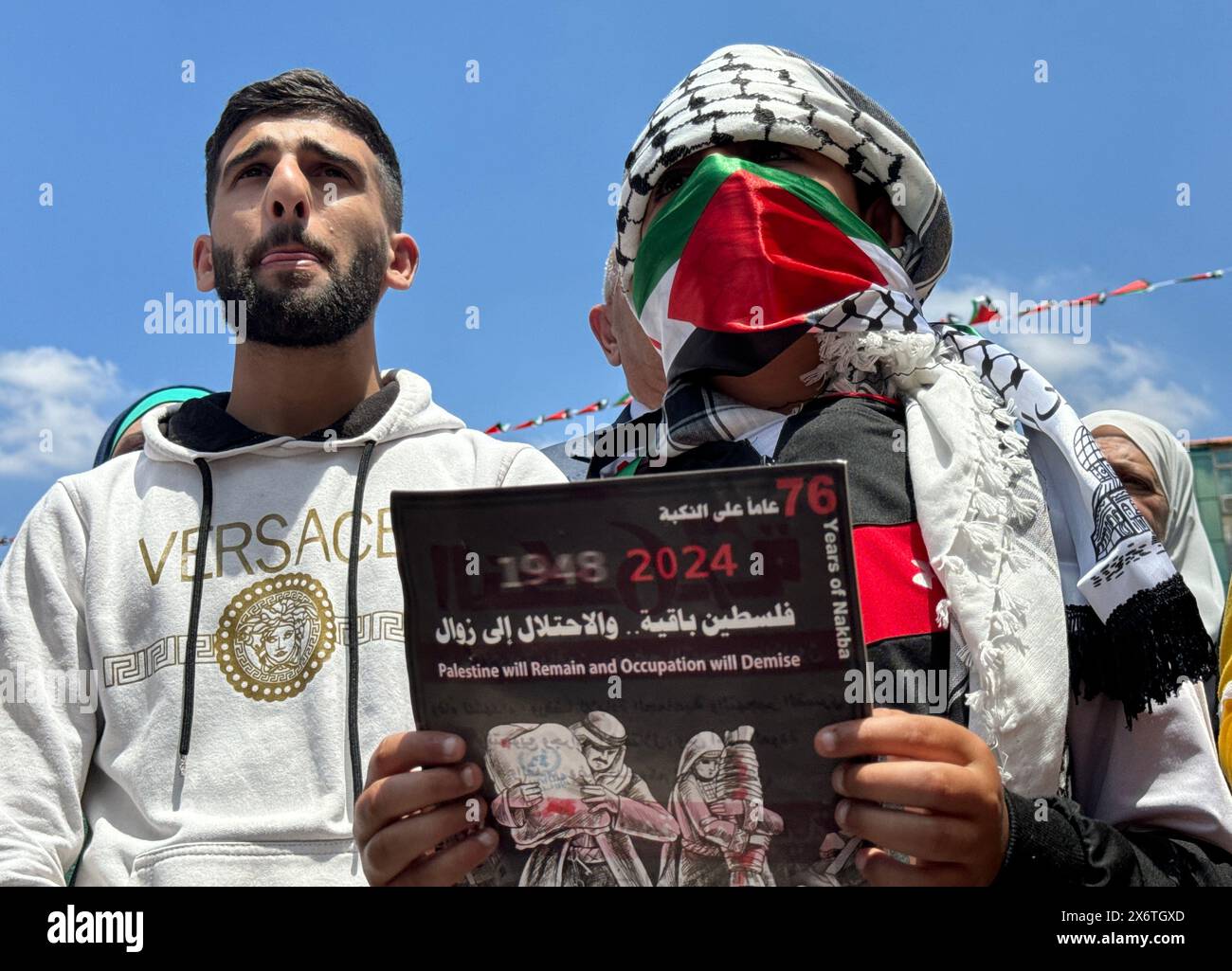 People putting up Palestinian flags march in Ramallah, West Bank on May ...