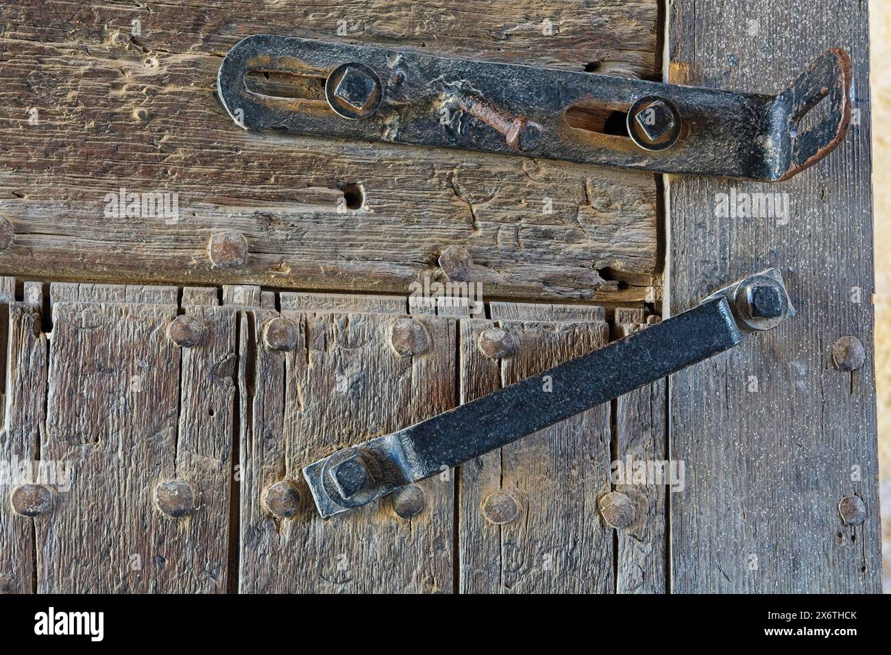 Close up black iron hardware on rustic timber door Stock Photo - Alamy