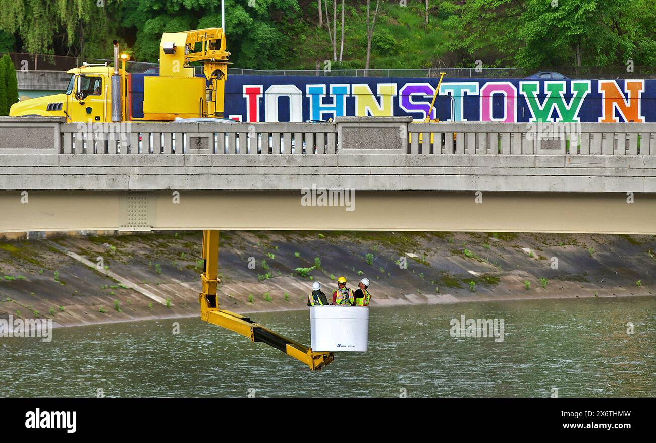 Pennsylvania Department of Transportation (PennDOT) workers use a ...