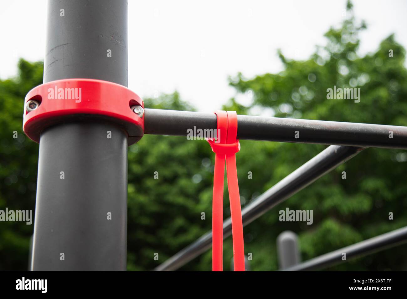 Elastic rubber band for exercise tied on a horizontal bar . Outdoor gym ...
