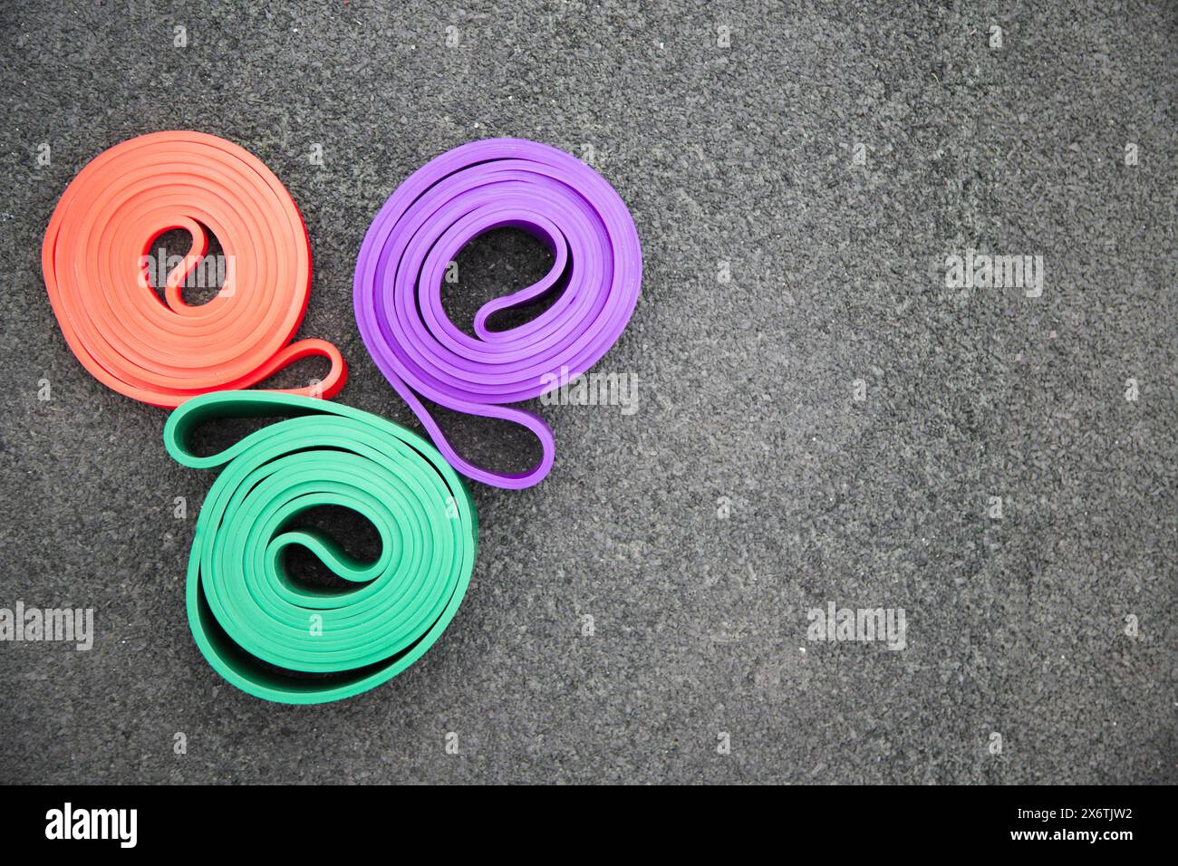 Sports equipment for pumping muscles . Background of colorful rubber ...
