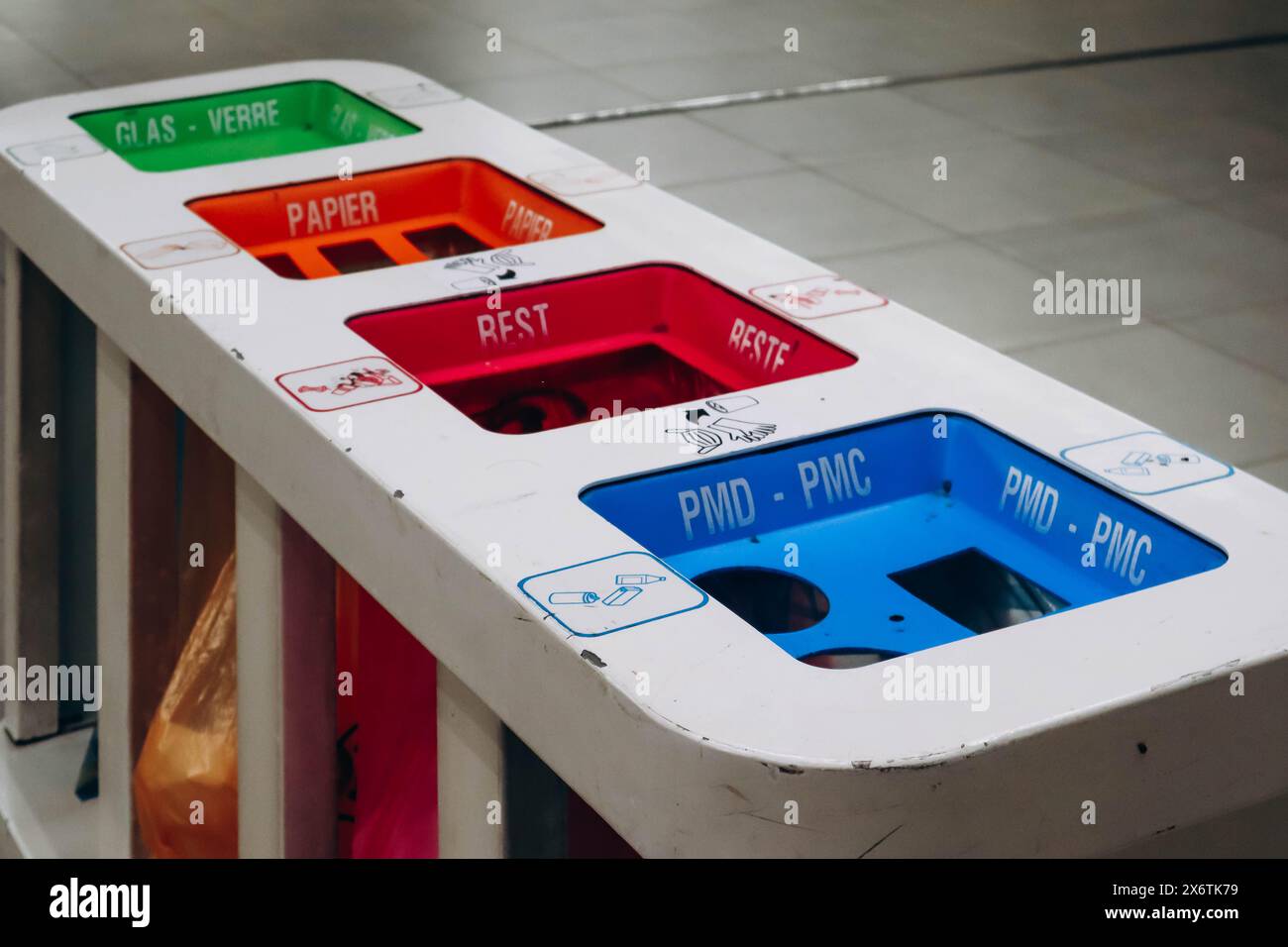 Trash bins for separate collection of waste into four categories at a ...
