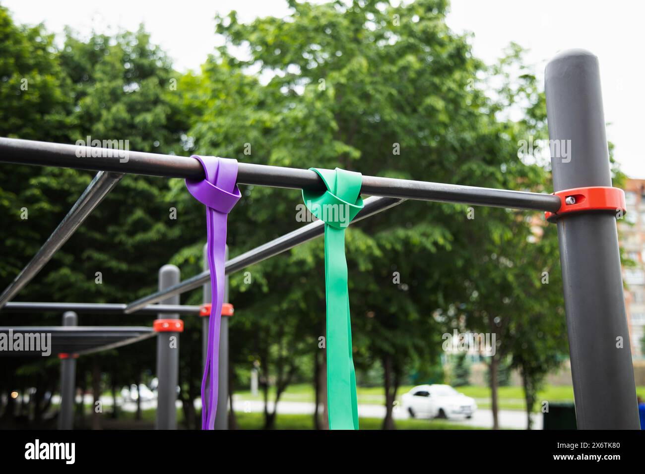 Purple and green Elastic rubber bands for exercise tied on a horizontal ...