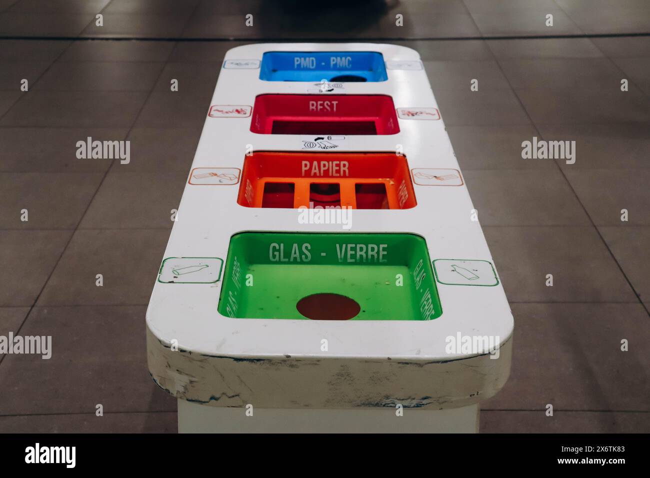 Trash bins for separate collection of waste into four categories at a ...