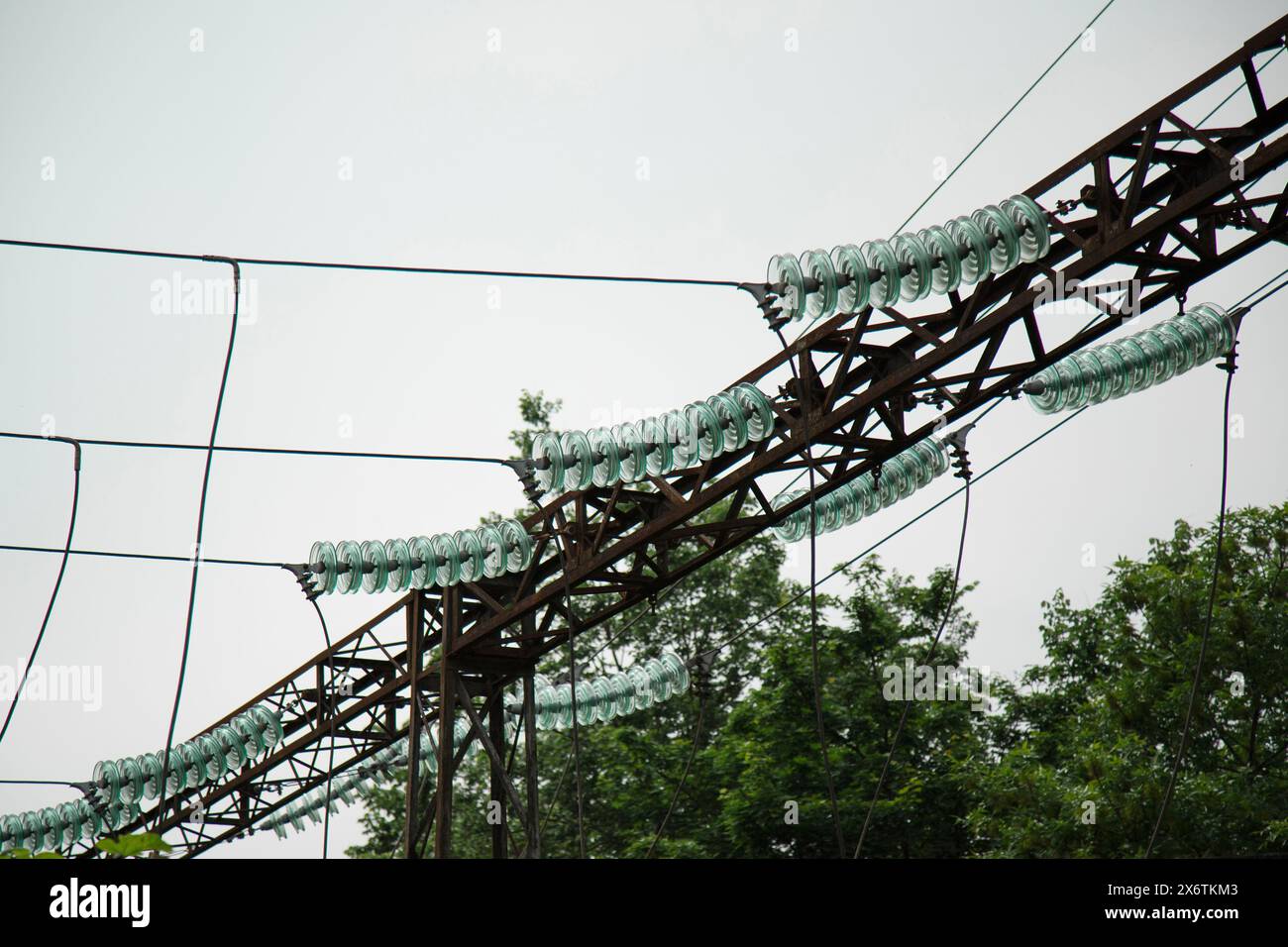 High voltage glass insulators on electric transmission line Stock Photo ...