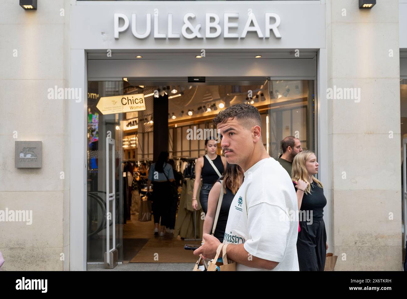 Shoppers walk past the Spanish multinational clothing design retail ...
