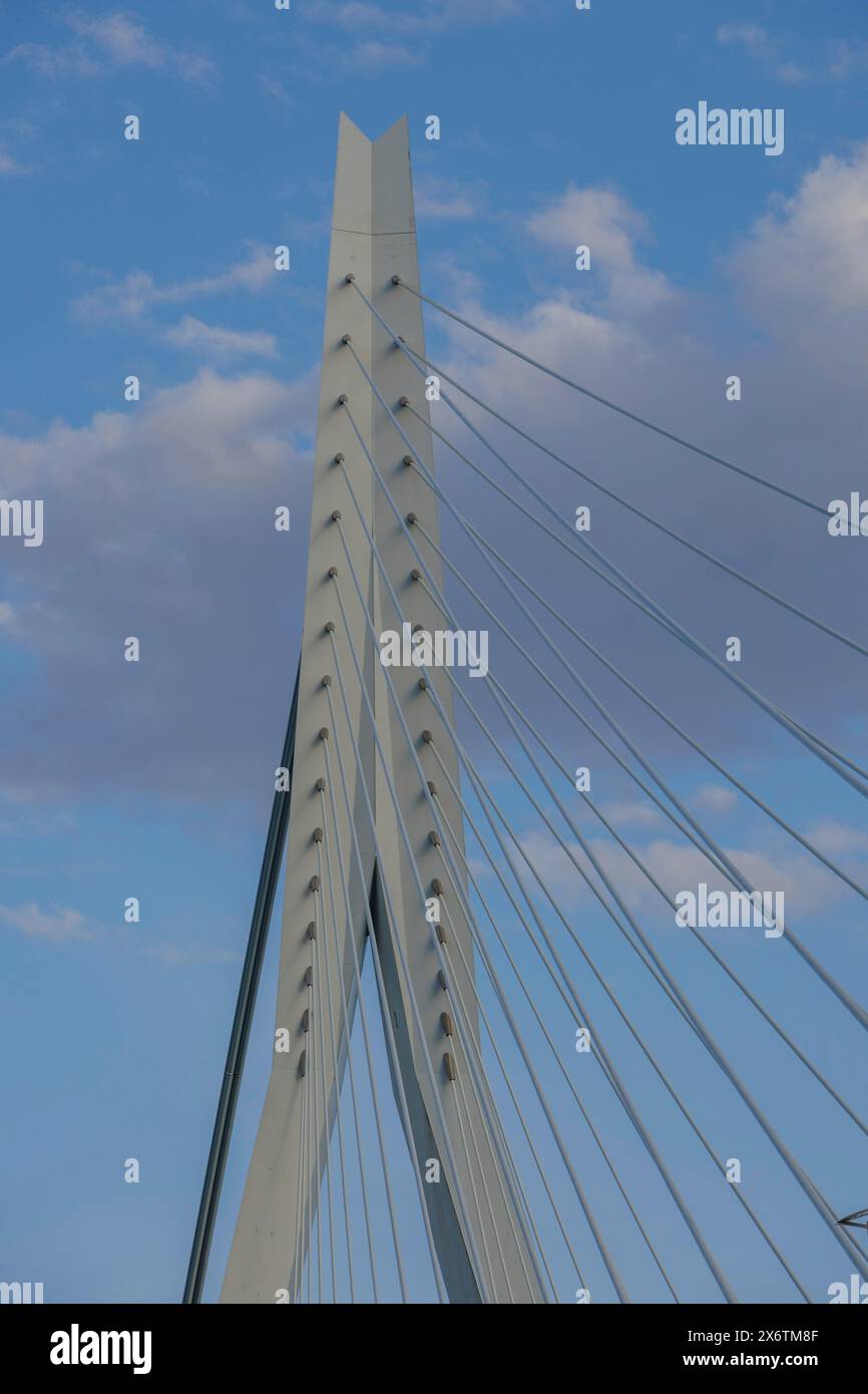 Modern cable bridge segment, against the blue sky with scattered clouds ...