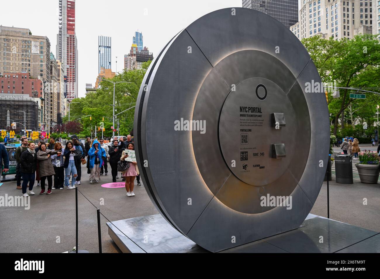 People interact with a massive circular livestream video "portal ...