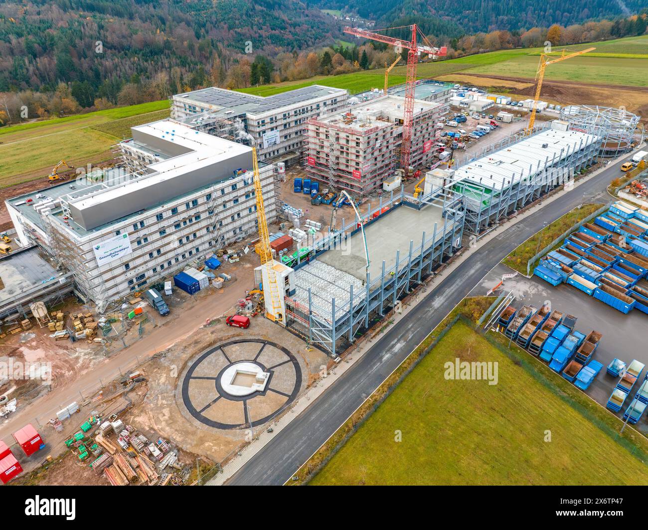 Spacious construction site in rural surroundings with several buildings ...