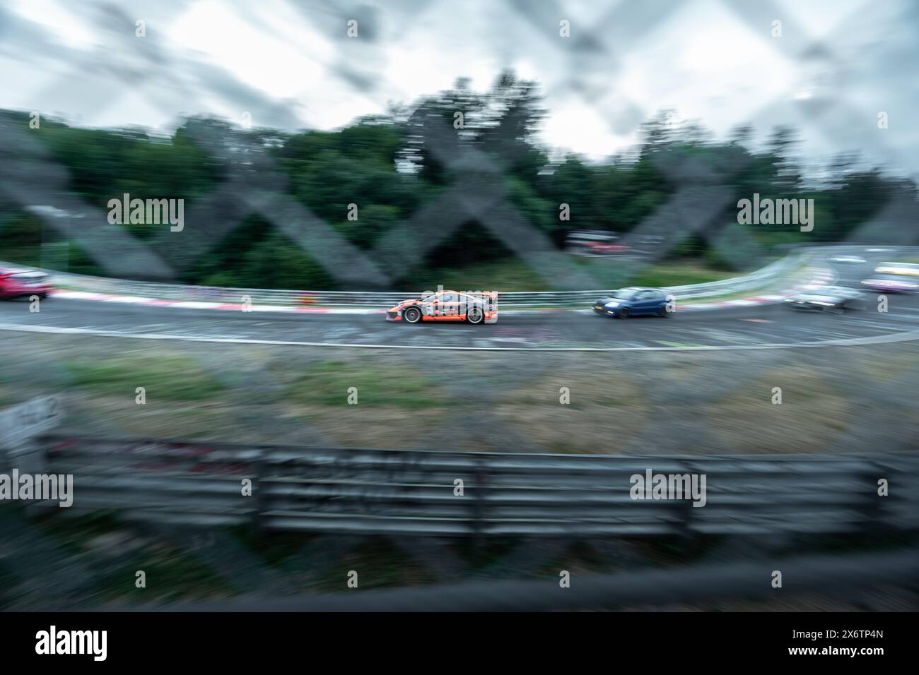 A racing car in action, captured with motion blur and visible through a ...