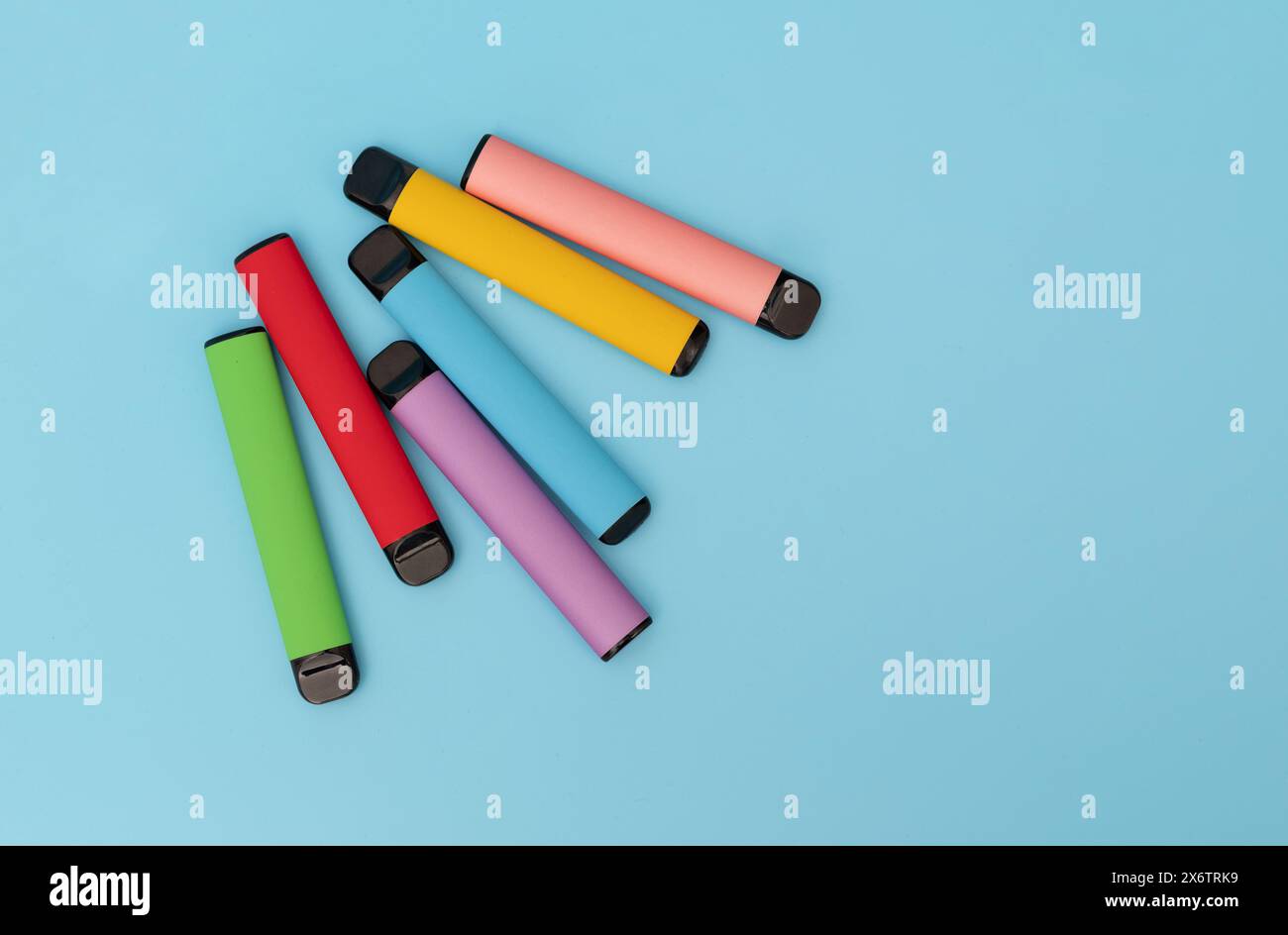 Set of colorful disposable electronic cigarettes on a blue background ...
