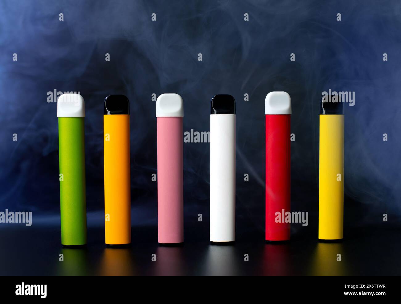 Set of colorful disposable electronic cigarettes on a black background ...