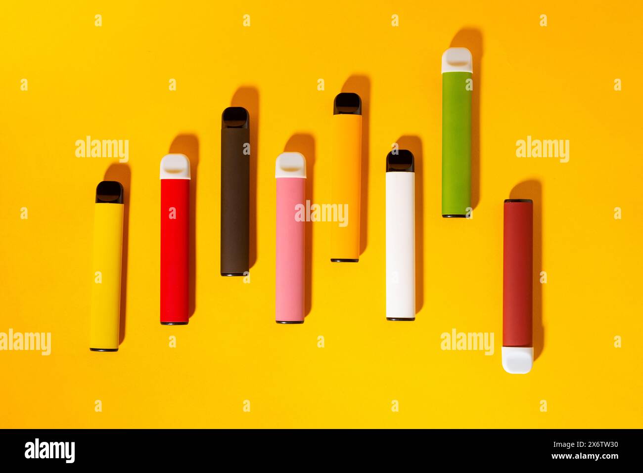 Layout of colorful disposable electronic cigarettes with shadows on a ...