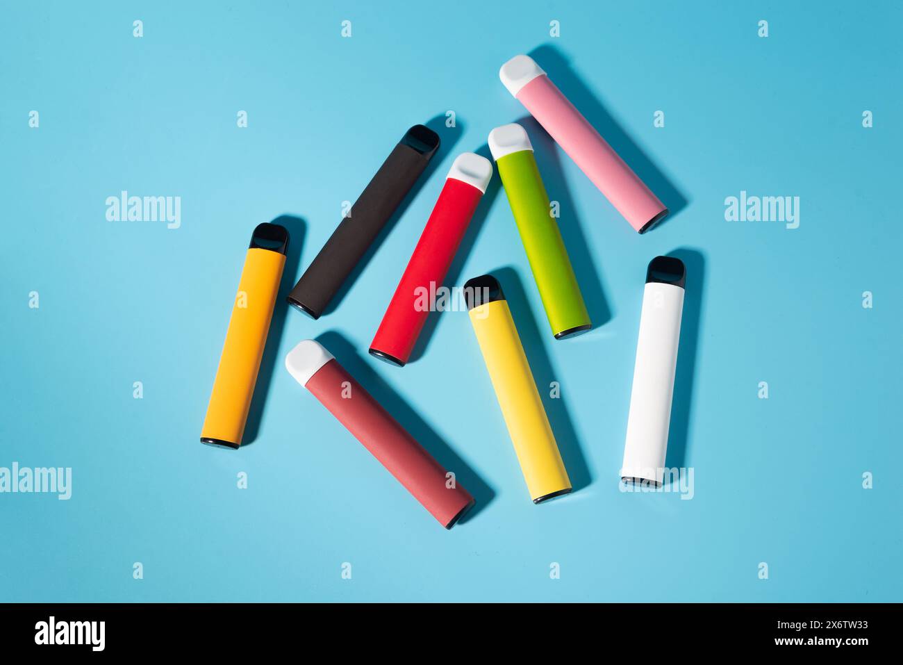 Layout of colorful disposable electronic cigarettes with shadows on a ...