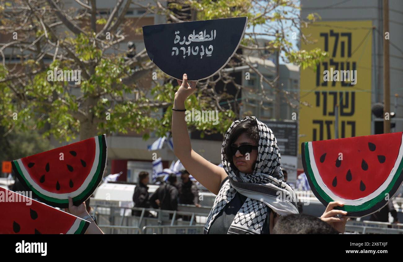 Israeli Arab students hold signs in the colors of the Palestinian flag ...