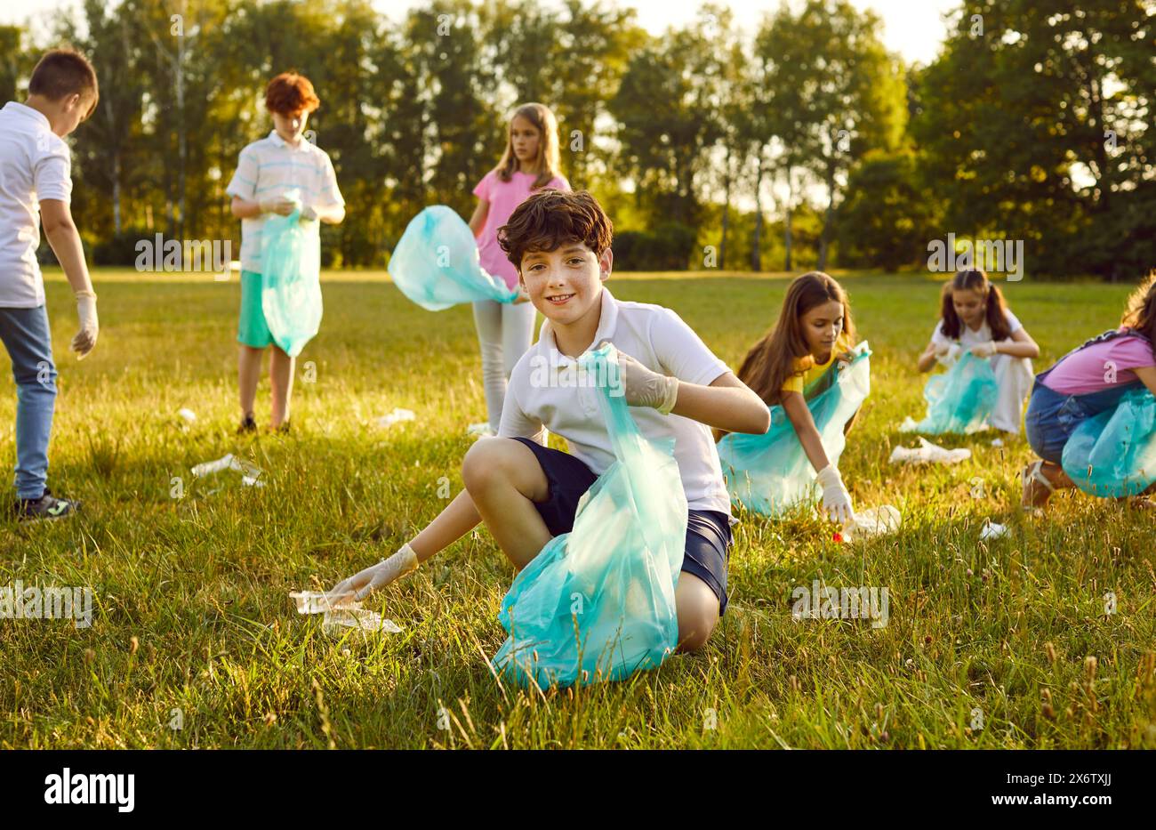 Child picking up garbage in park hi-res stock photography and images ...