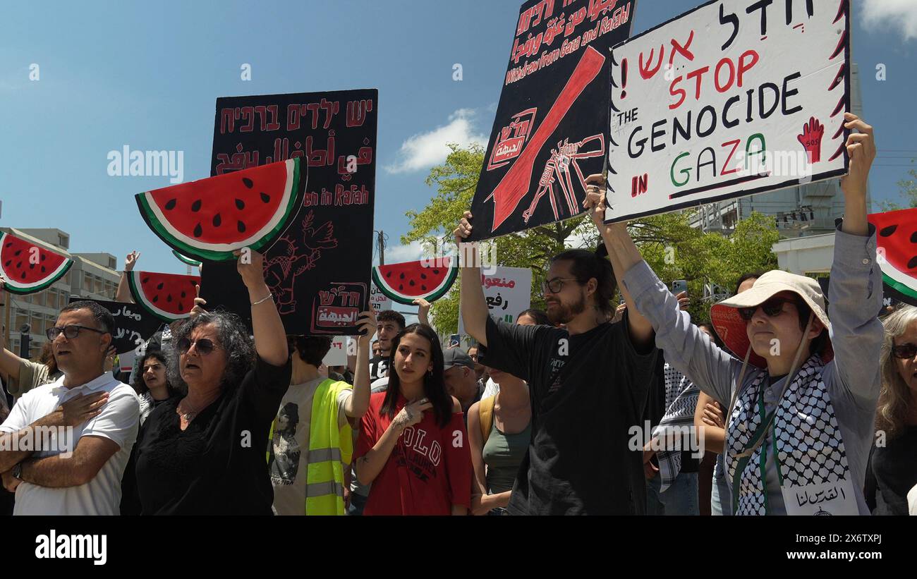 Israeli Arab students hold signs in the colors of the Palestinian flag ...