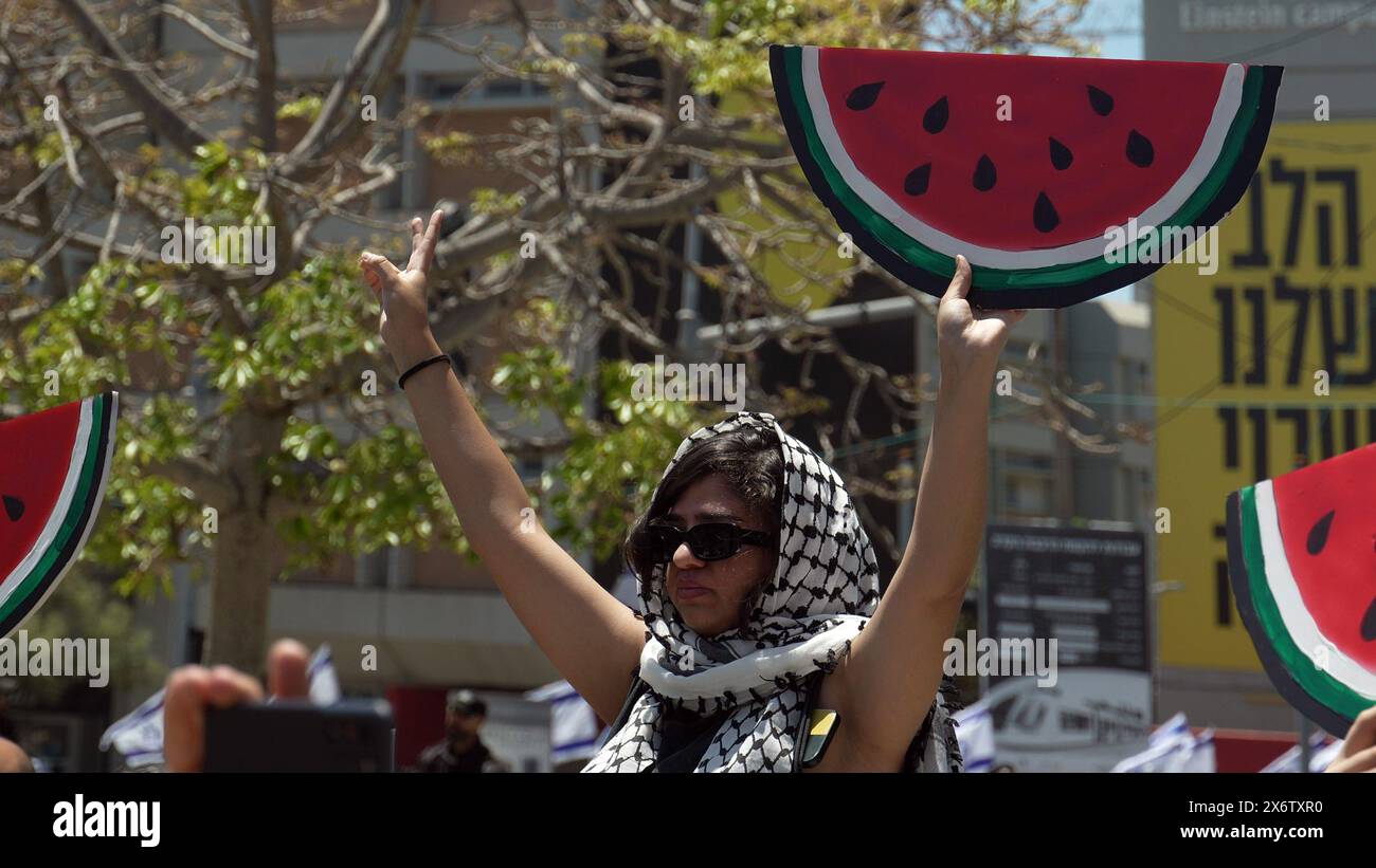 Israeli Arab students hold signs in the colors of the Palestinian flag ...