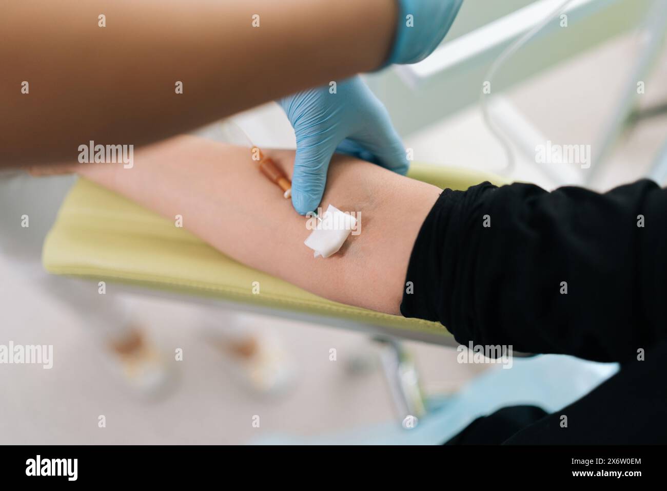 Top view of unrecognizable nurse giving intravenous infusion to female ...
