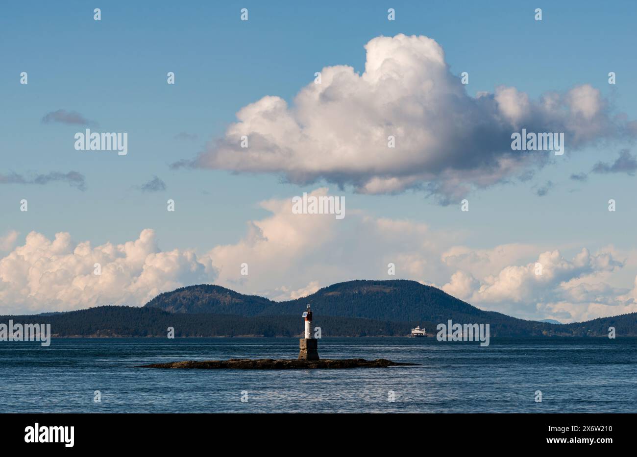 Ships pass in the distance while a marine marker on a small island ...