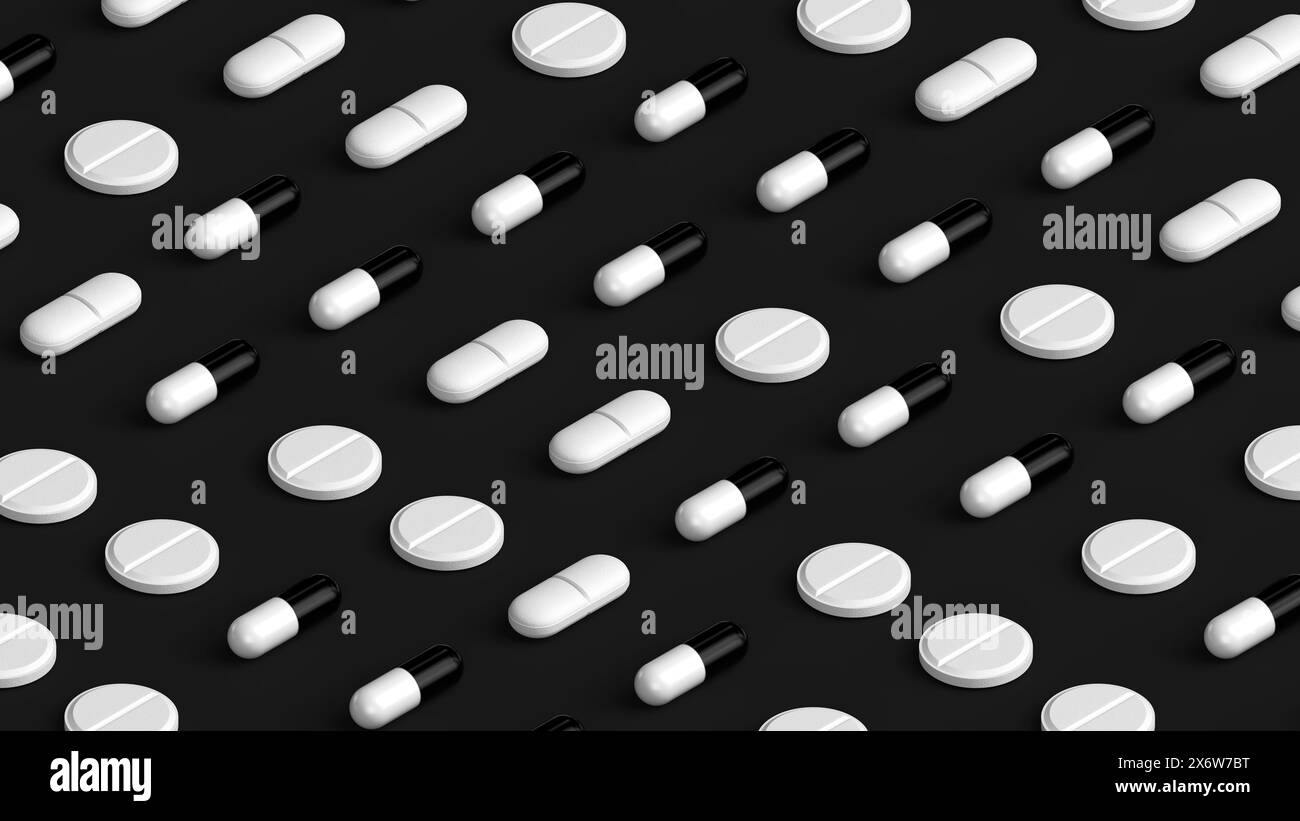 Many white black capsules, tablets and pills on black background ...