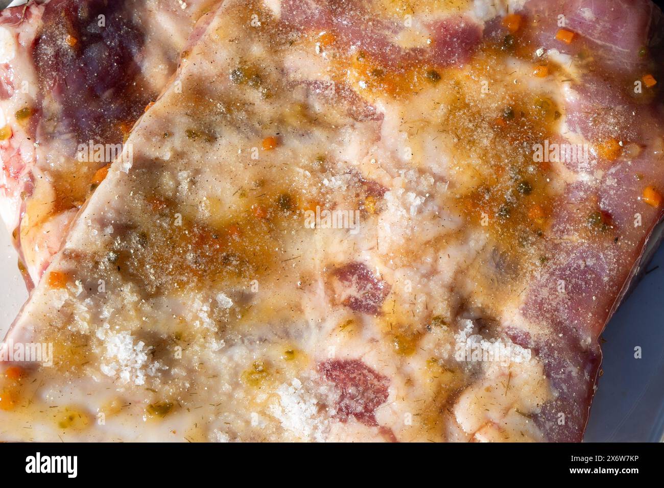 Raw meat rib background with salt and herbs Stock Photo - Alamy
