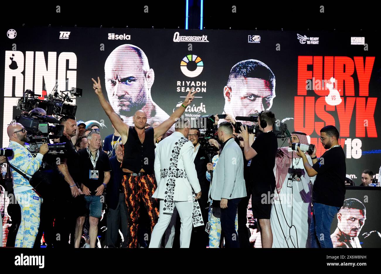 Tyson Fury (centre left) and Oleksandr Usyk during a press conference ...