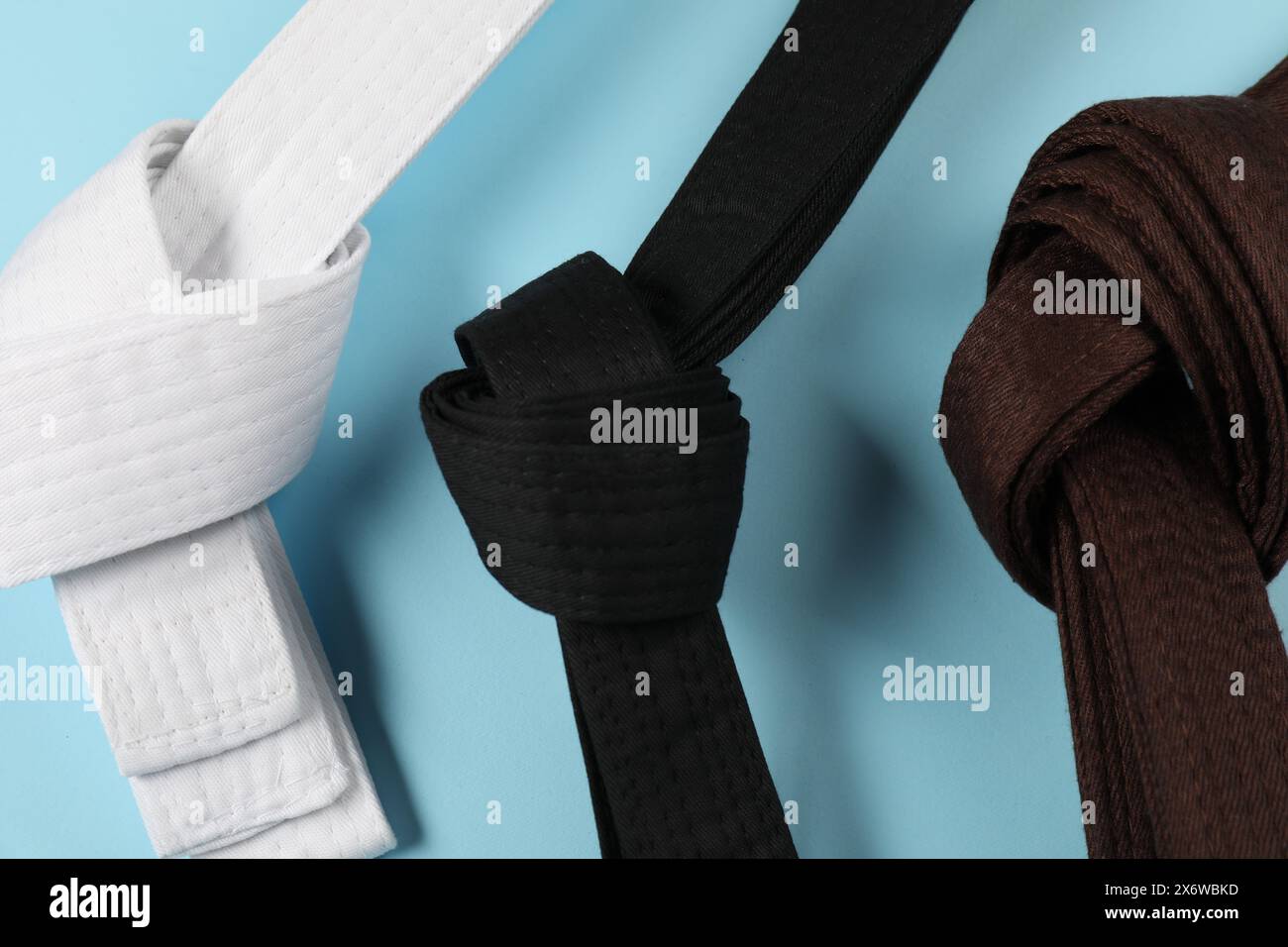 Karate belts on light blue background, flat lay Stock Photo - Alamy