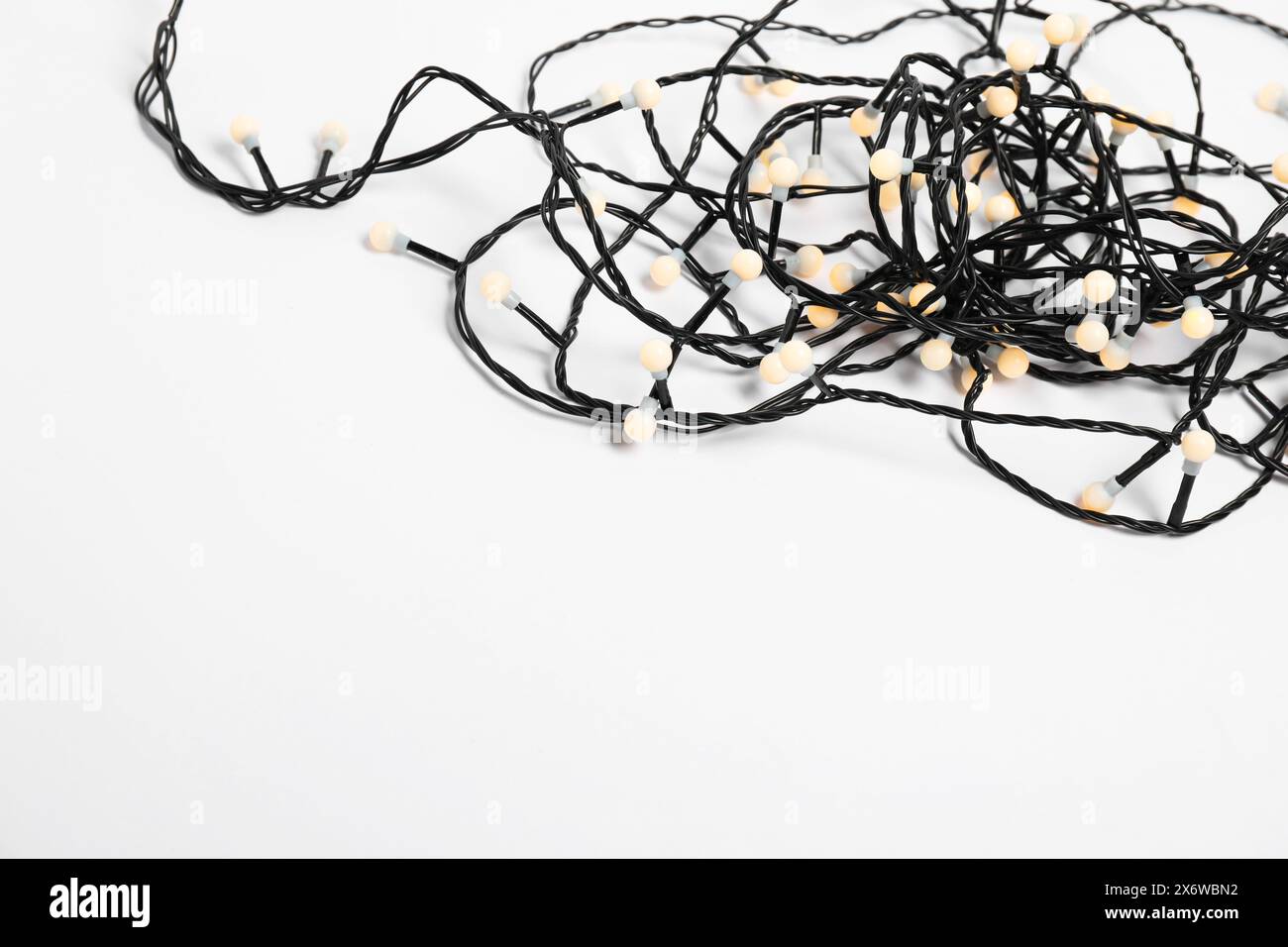 Tangled strings of Christmas lights on white background Stock Photo - Alamy