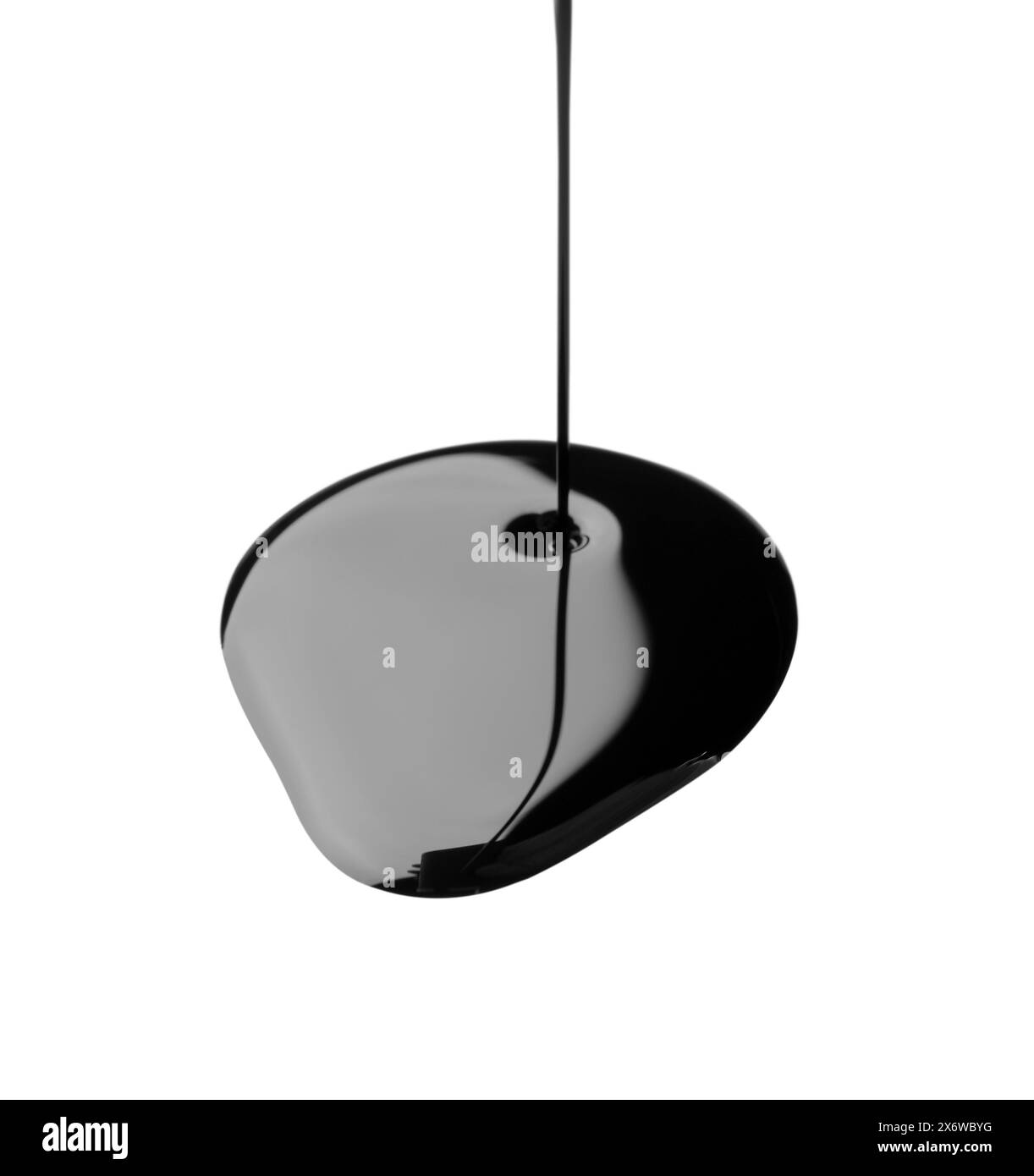 Oil pouring to puddle on white background Stock Photo - Alamy