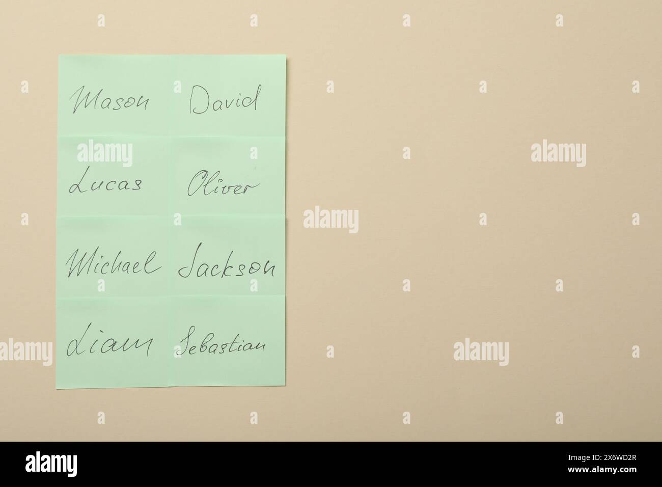 Choosing baby's name. Paper stickers with different names on beige ...