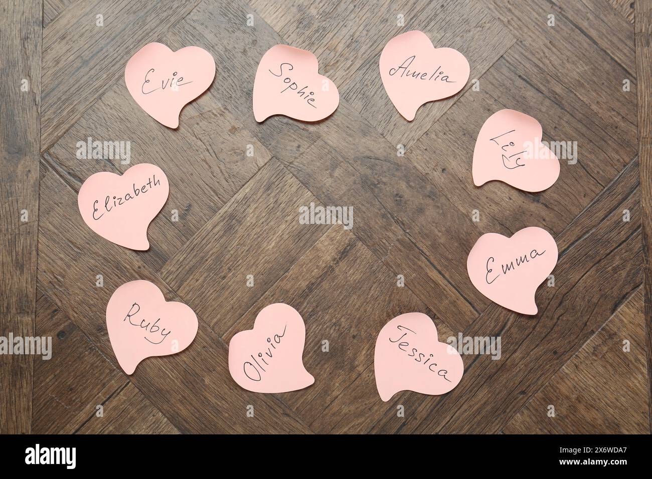 Choosing baby's name. Paper stickers with different names on wooden ...