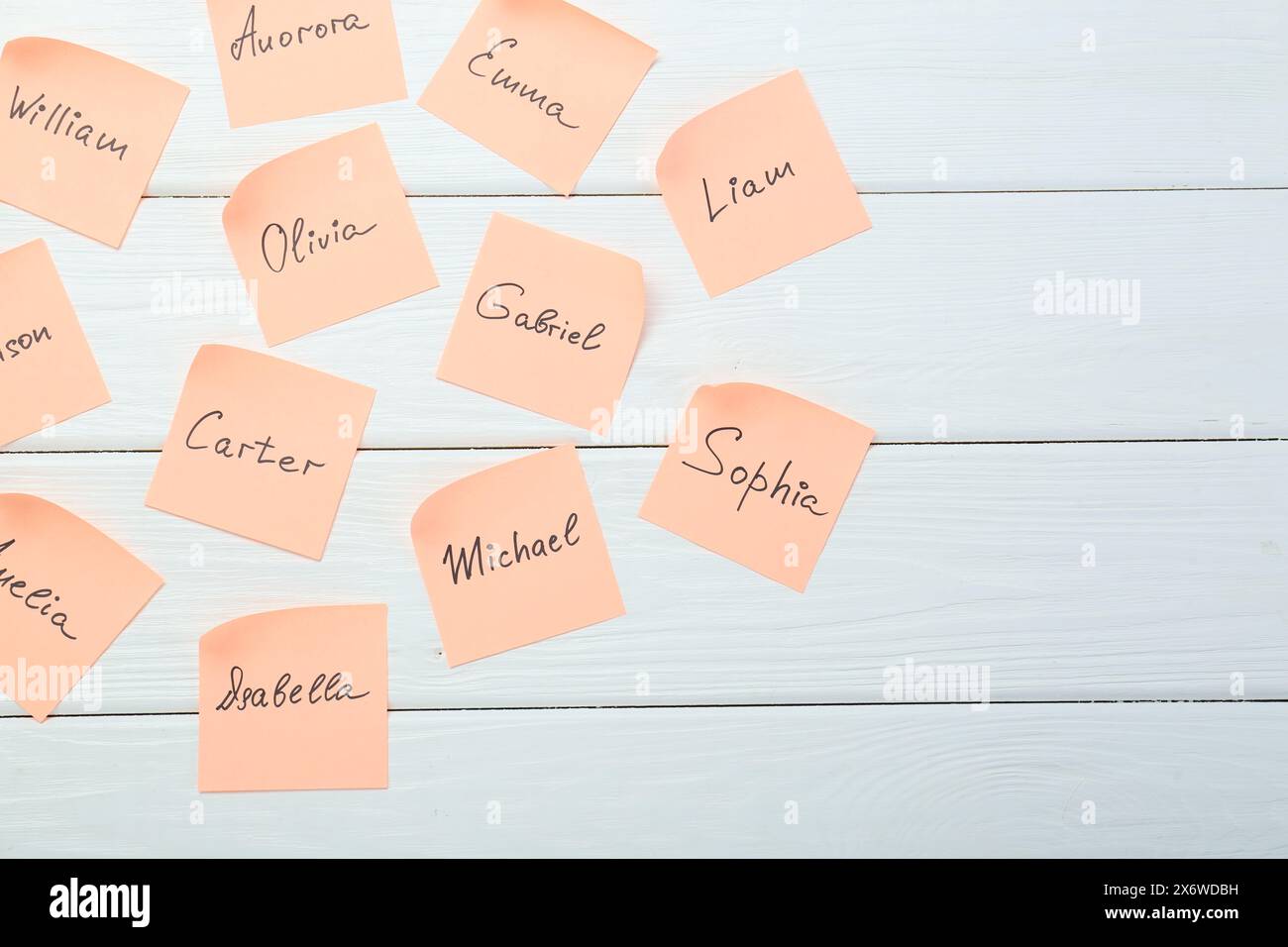 Choosing baby's name. Paper stickers with different names on white ...