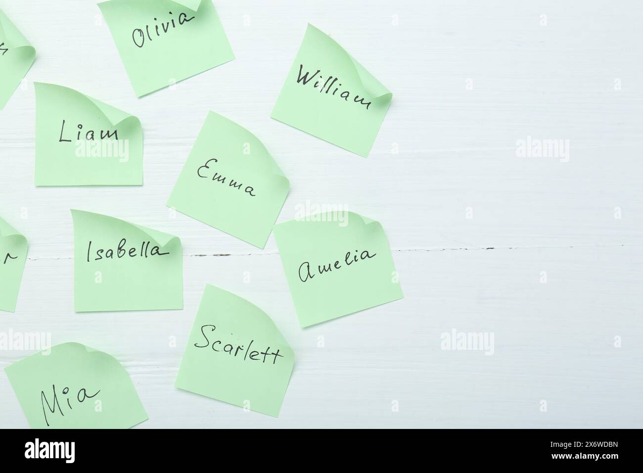 Choosing baby's name. Paper stickers with different names on white ...