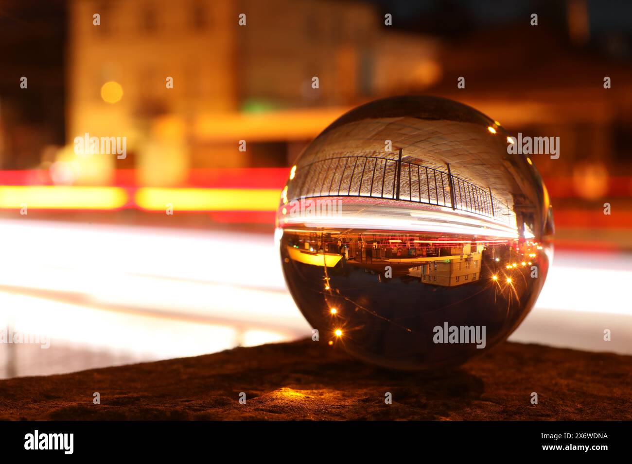 Beautiful city street, overturned reflection. Crystal ball at night ...