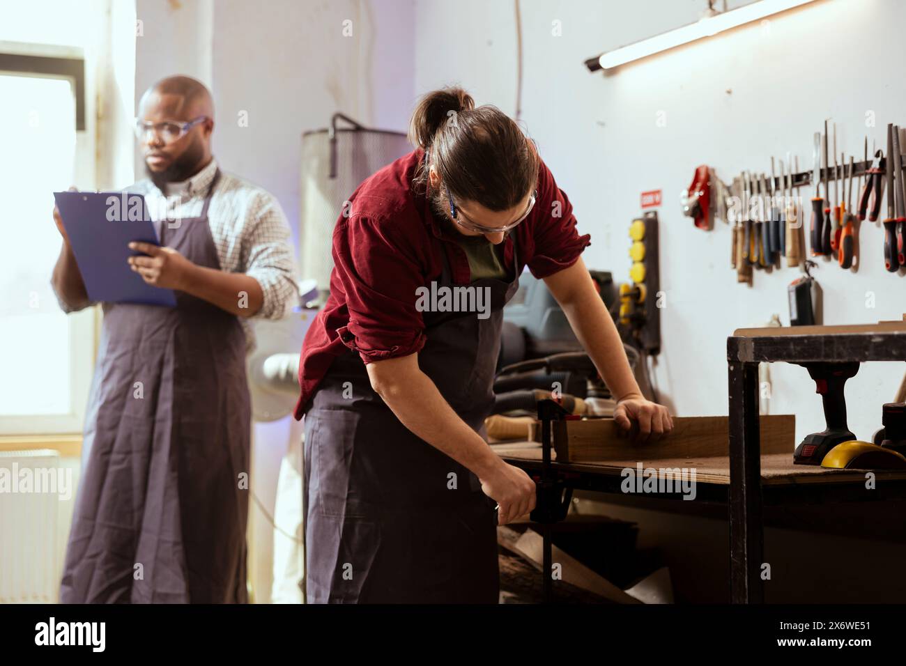 Woodworker using bench vise to hold lumber block, starting furniture ...