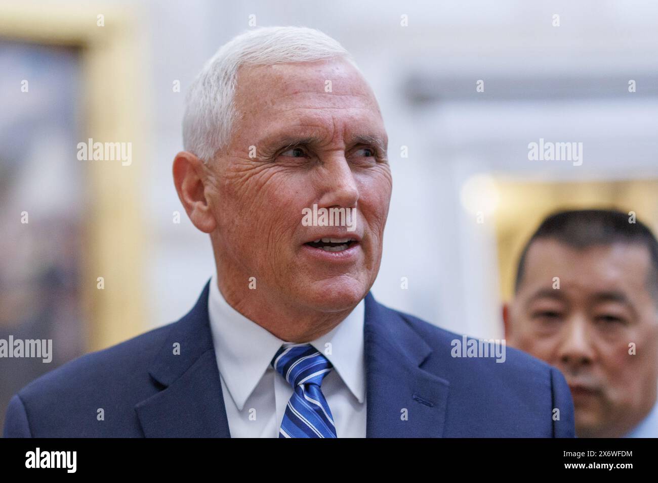Former US Vice President Mike Pence walks through the Rotunda of the US ...