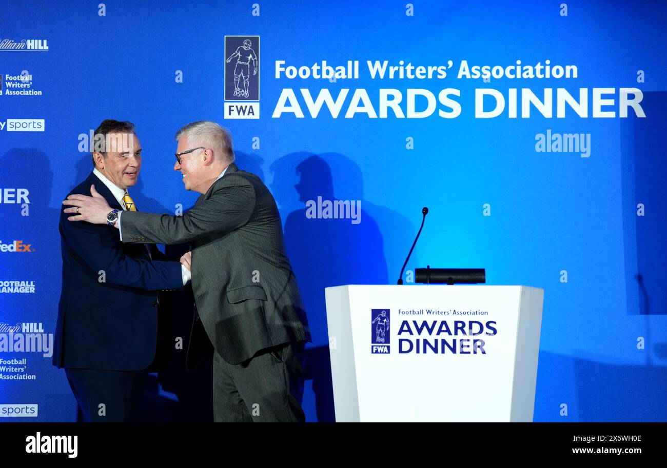 Gerry Cox (left) on stage to receive the Lifetime Membership Award from ...